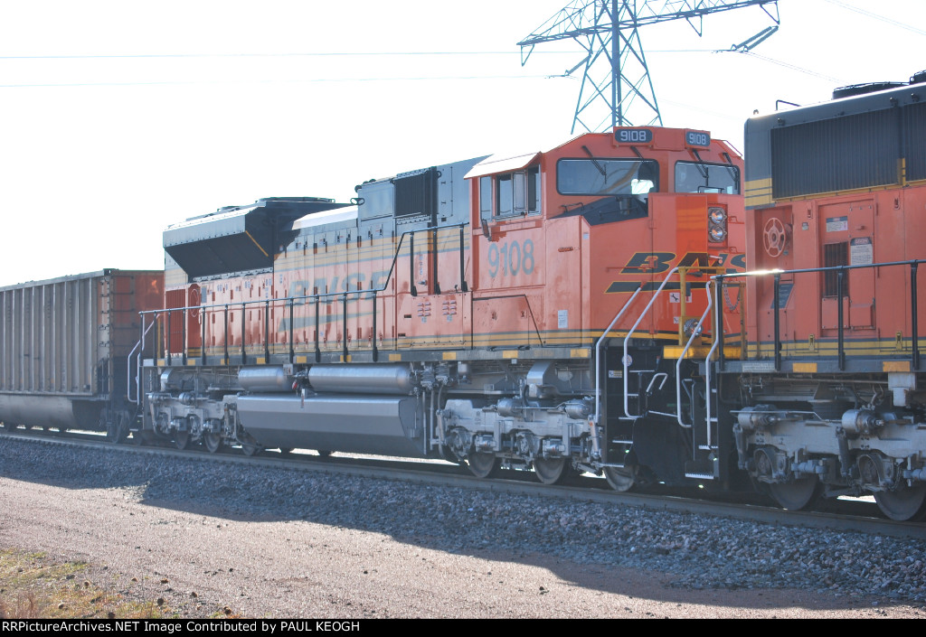 BNSF 9108 sits on the siding just east of the main yard as the Lead Rear DPU on a eastbound ...